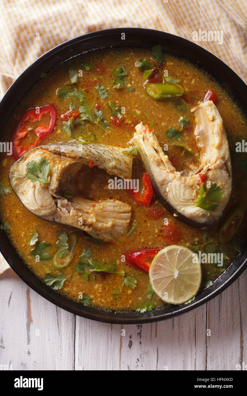 Delicious spicy fish curry with cilantro close up on the table ...