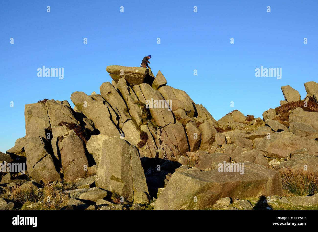 A man sitting on the summit of Carn Meini Carn Menyn bluestones preseli ...