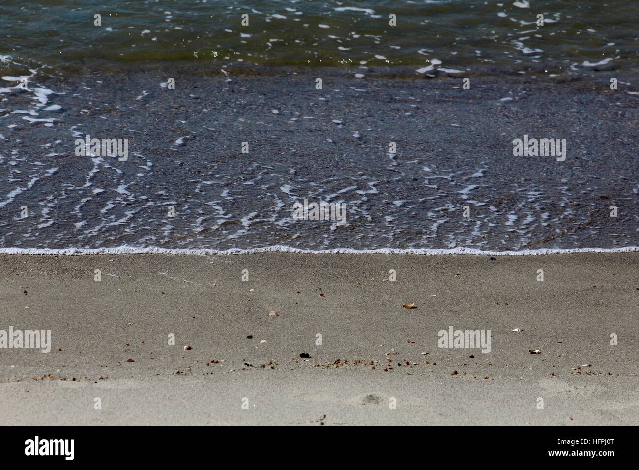 The tide rolling in on the beach Stock Photo - Alamy