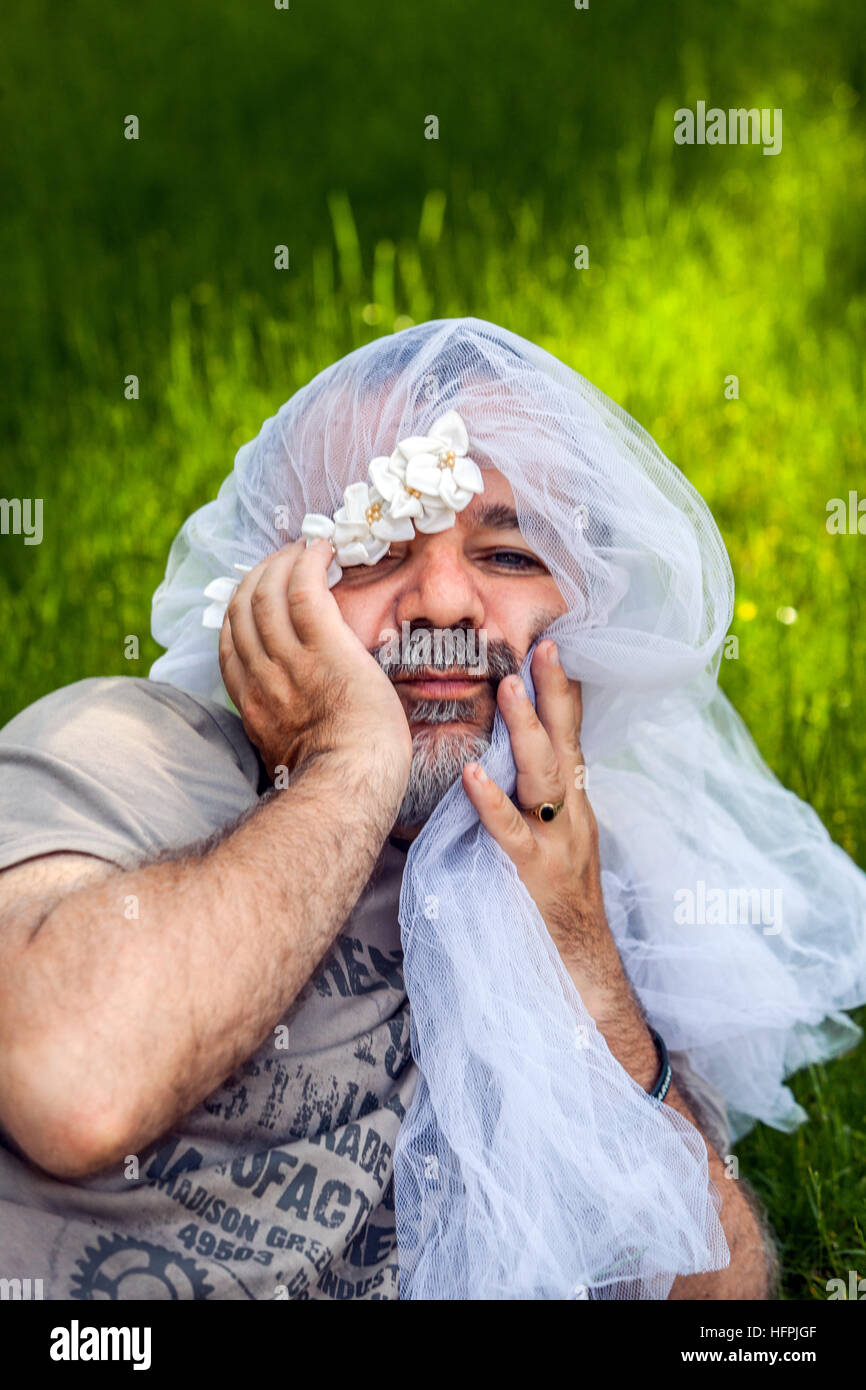 A man alone with a gray beard and a white veil on his head Stock Photo ...