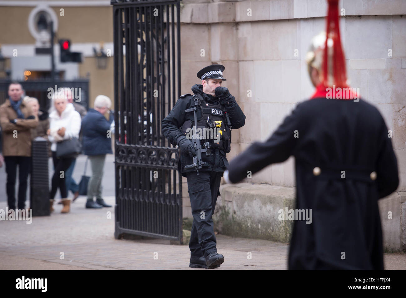 An armed police officer walks in Horse Guards Parade in central London ...