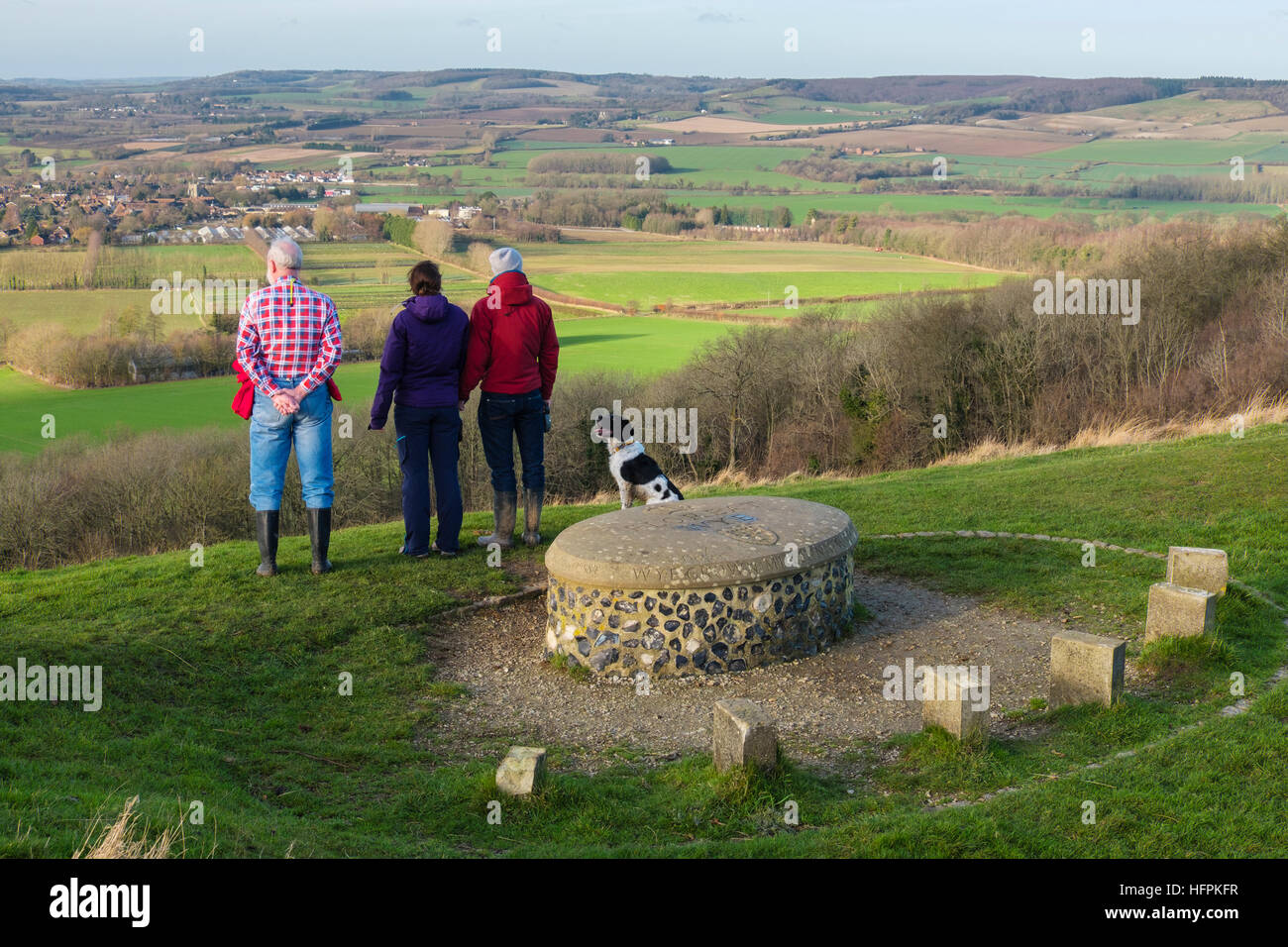 People looking at view of countryside by Wye Crown Millennium stone in ...