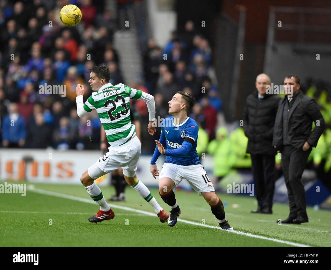 Rangers Barry McKay flicks the ball over Celtic"s Mikael Lustig with ...