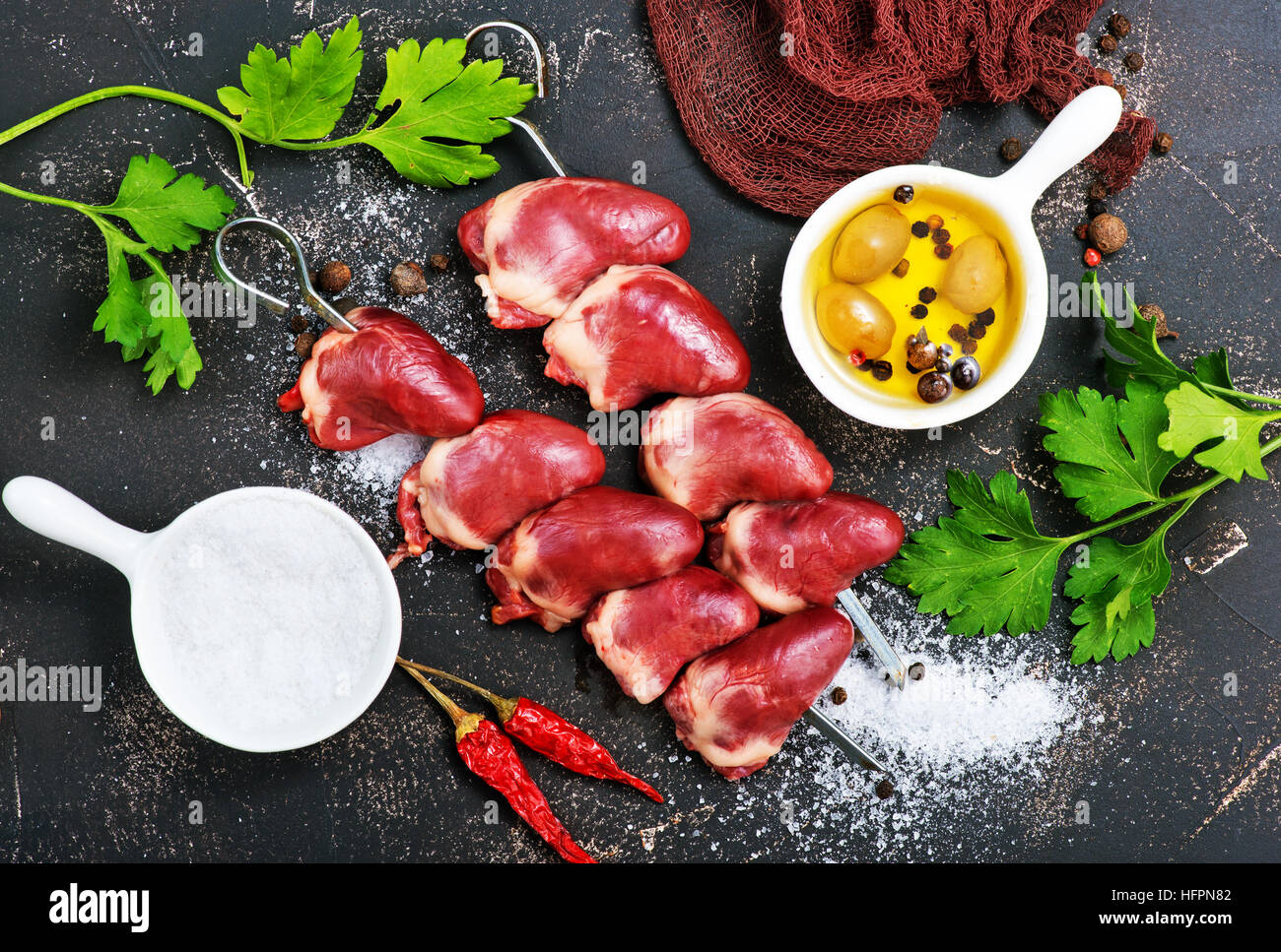 raw duck hearts with spice and salt on a table Stock Photo - Alamy