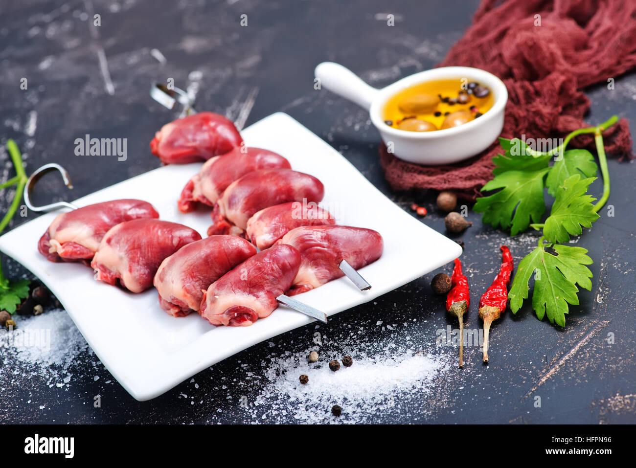 raw duck hearts with spice and salt on a table Stock Photo - Alamy