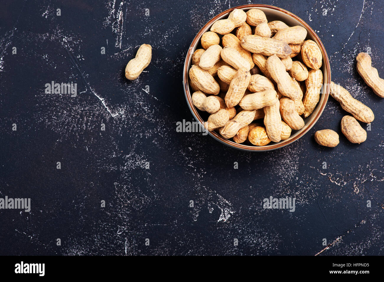 peanuts in bowl and on a table Stock Photo - Alamy