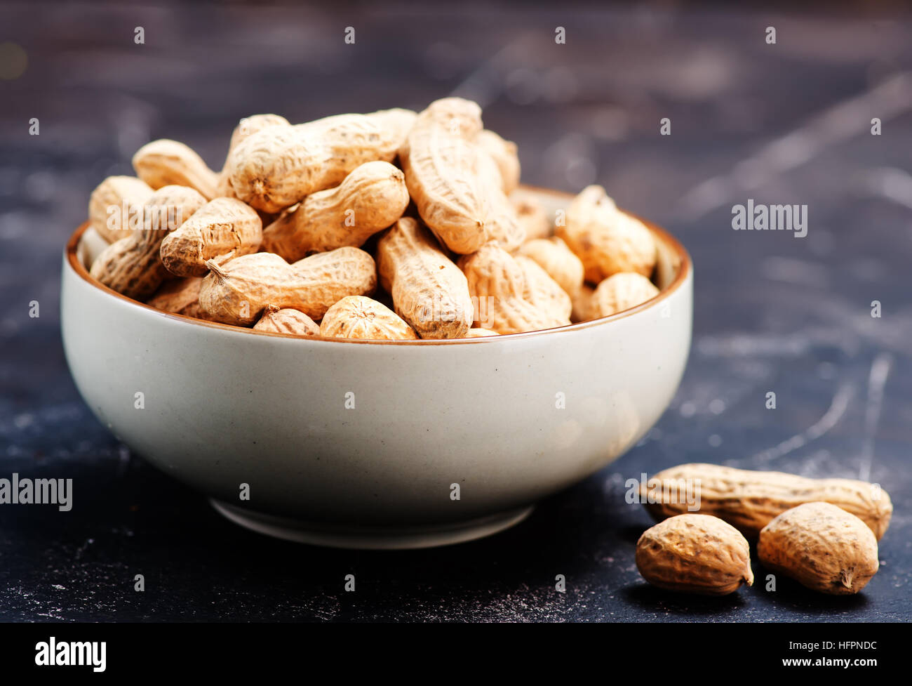 peanuts in bowl and on a table Stock Photo - Alamy