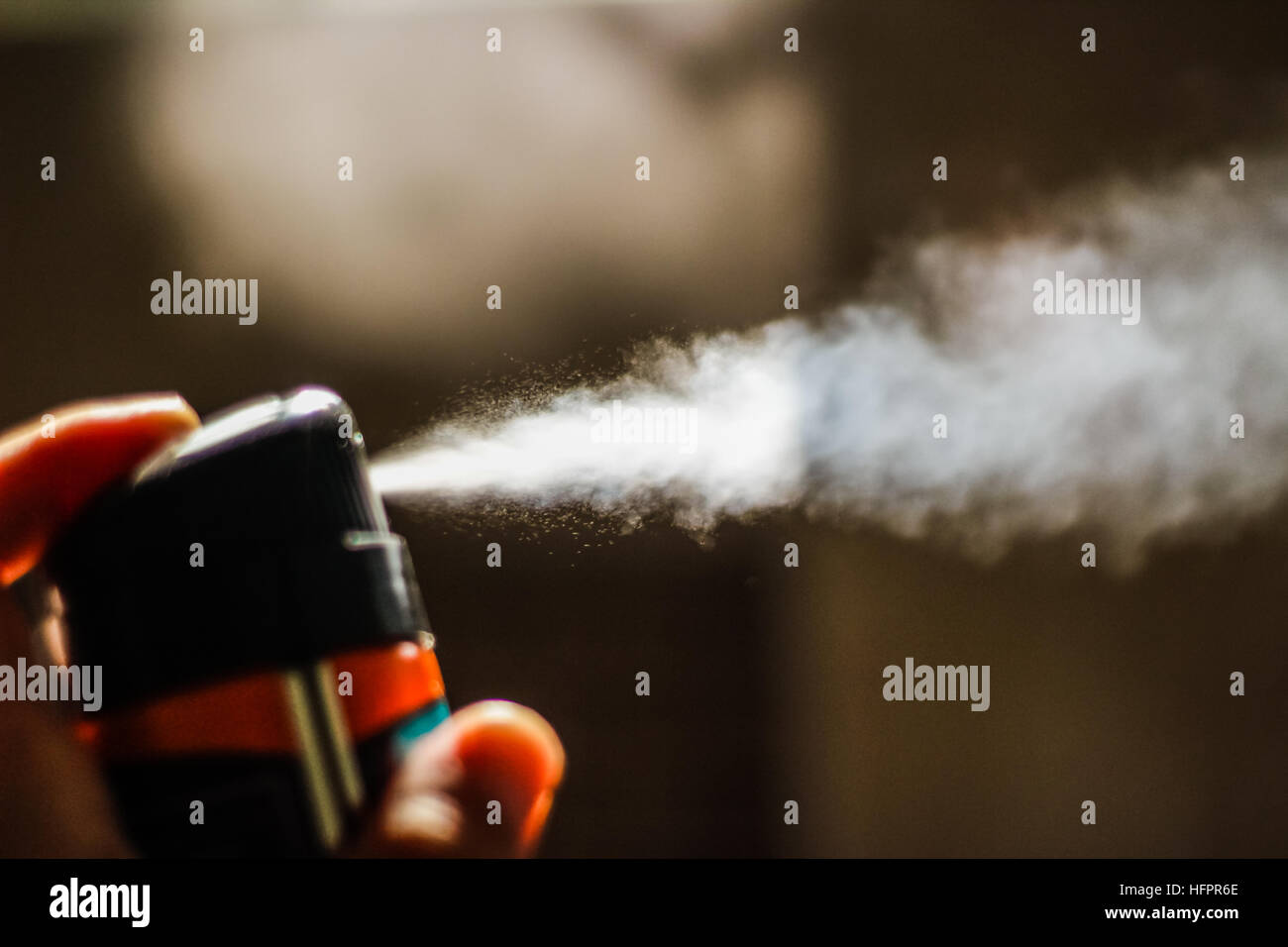 Photograph of a human hand holding an atomizer Stock Photo - Alamy