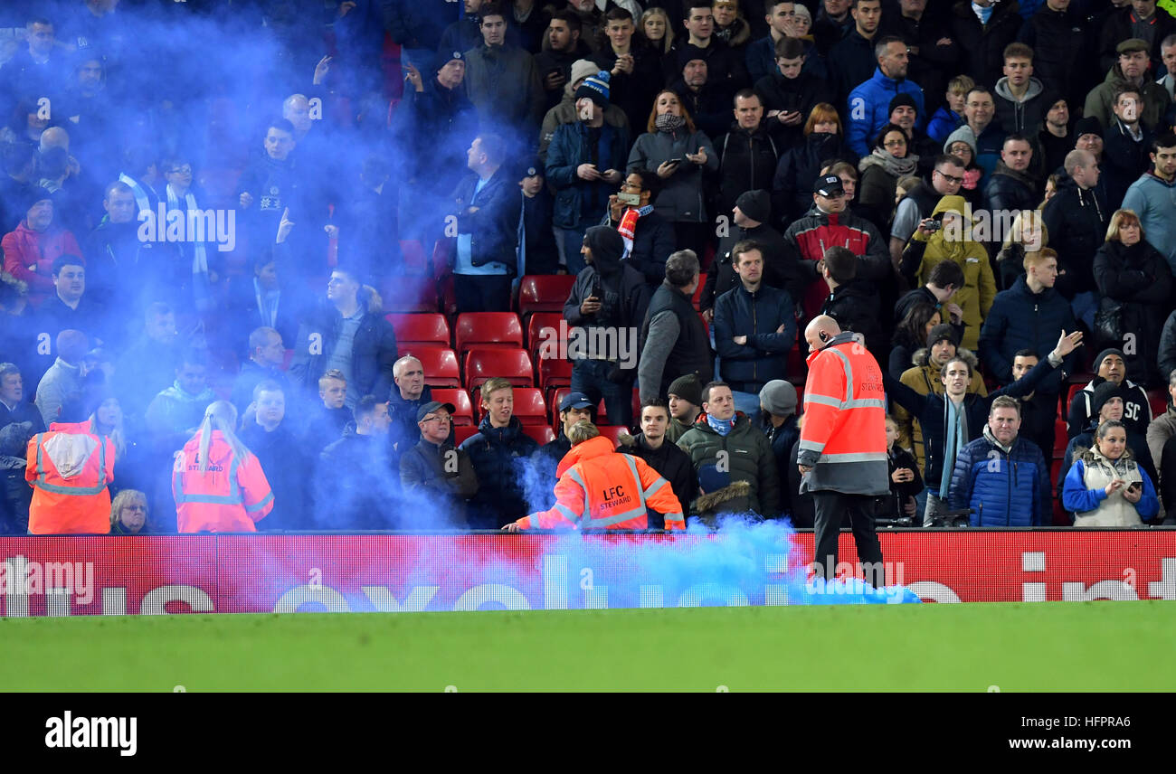 A blue flare is thrown onto the pitch during the Premier League match ...