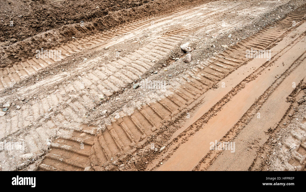 Bulldozer tracks on a surface of brown and gray sand Stock Photo - Alamy