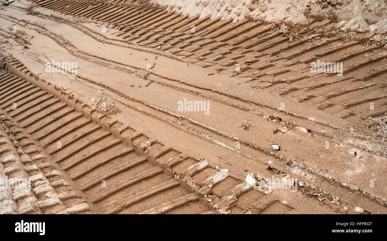 Bulldozer tracks on a surface of brown and gray sand Stock Photo - Alamy