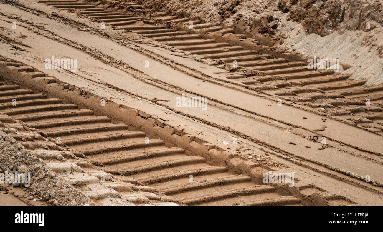 Bulldozer tracks on a surface of brown and gray sand Stock Photo - Alamy
