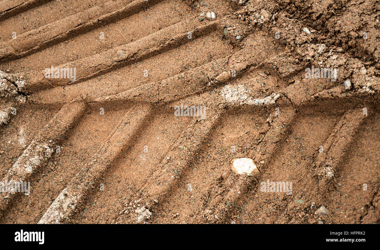 Bulldozer tracks on a surface of brown and gray sand Stock Photo - Alamy