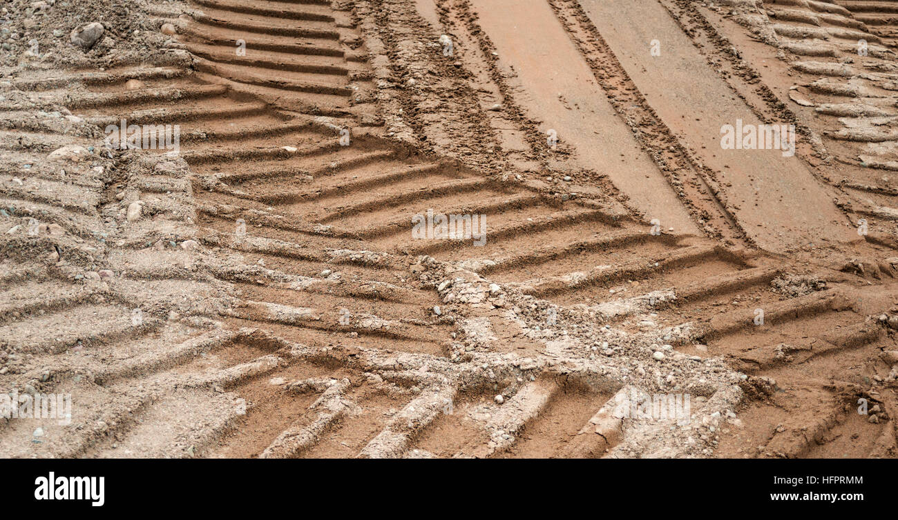 Bulldozer tracks on a surface of brown and gray sand Stock Photo - Alamy