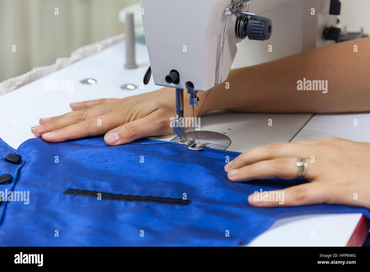 Women's hands behind her sewing blue Stock Photo - Alamy