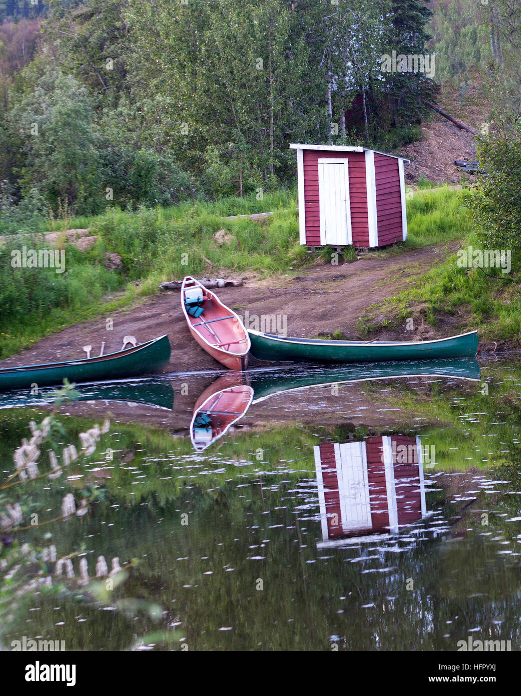 Reflections of boats and boathouse Stock Photo - Alamy