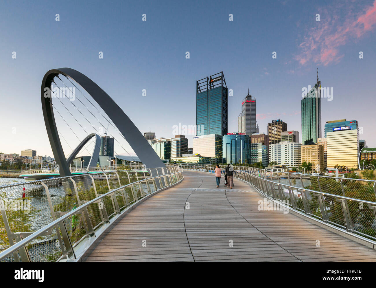 Twilight view along the Elizabeth Quay pedestrian bridge to the city ...