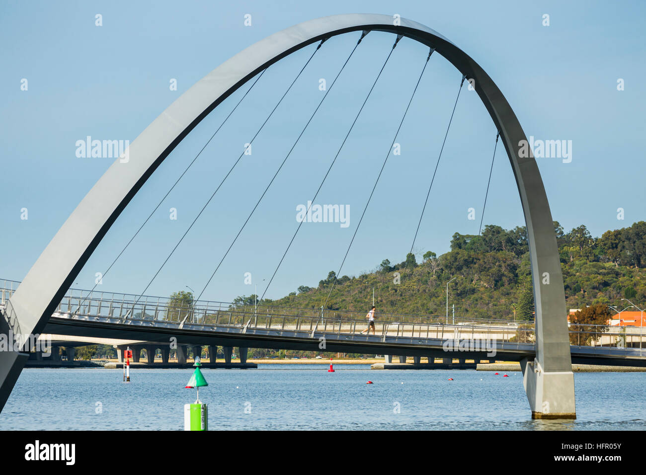 Jogger crossing the Elizabeth Quay Bridge - a pedestrian bridge on the ... Jogger crossing the Elizabeth Quay Bridge - a pedestrian bridge on the ...