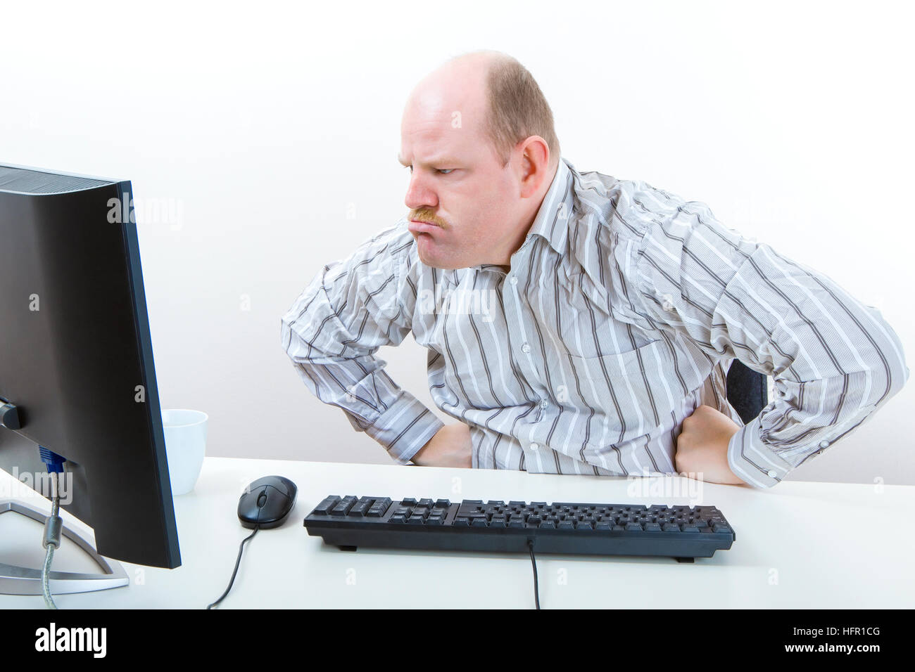 Angry Businessman Looking At Computer On Desk Stock Photo - Alamy