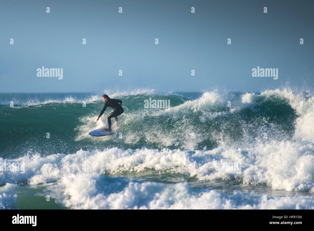 A surfer in spectacular action at Fistral in Newquay, Cornwall, England ...
