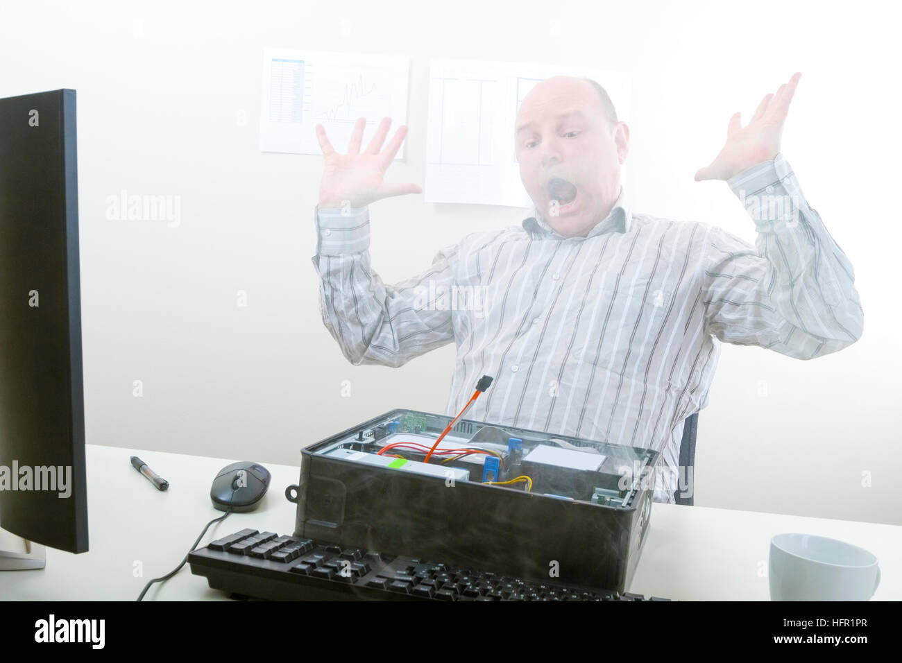 Shocked Businessman Looking At Smoke Emerging From Computer Stock Photo ...