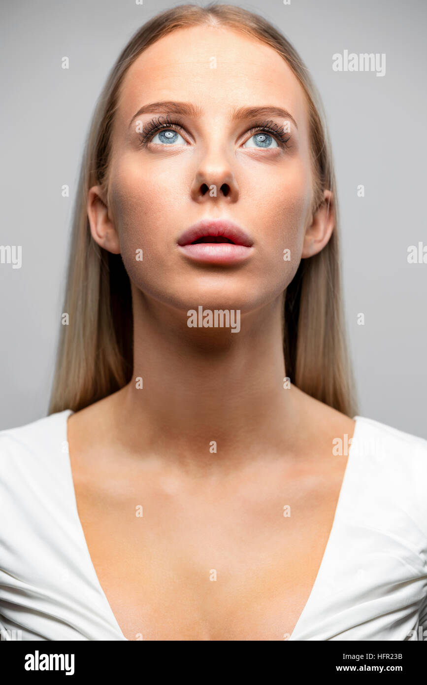 Young woman looking up in the sky Stock Photo - Alamy