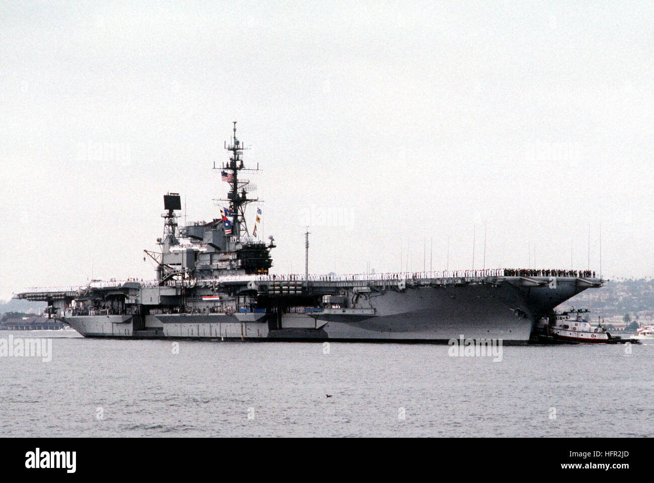 Crew members man the rails aboard the aircraft carrier USS MIDWAY (CV ...