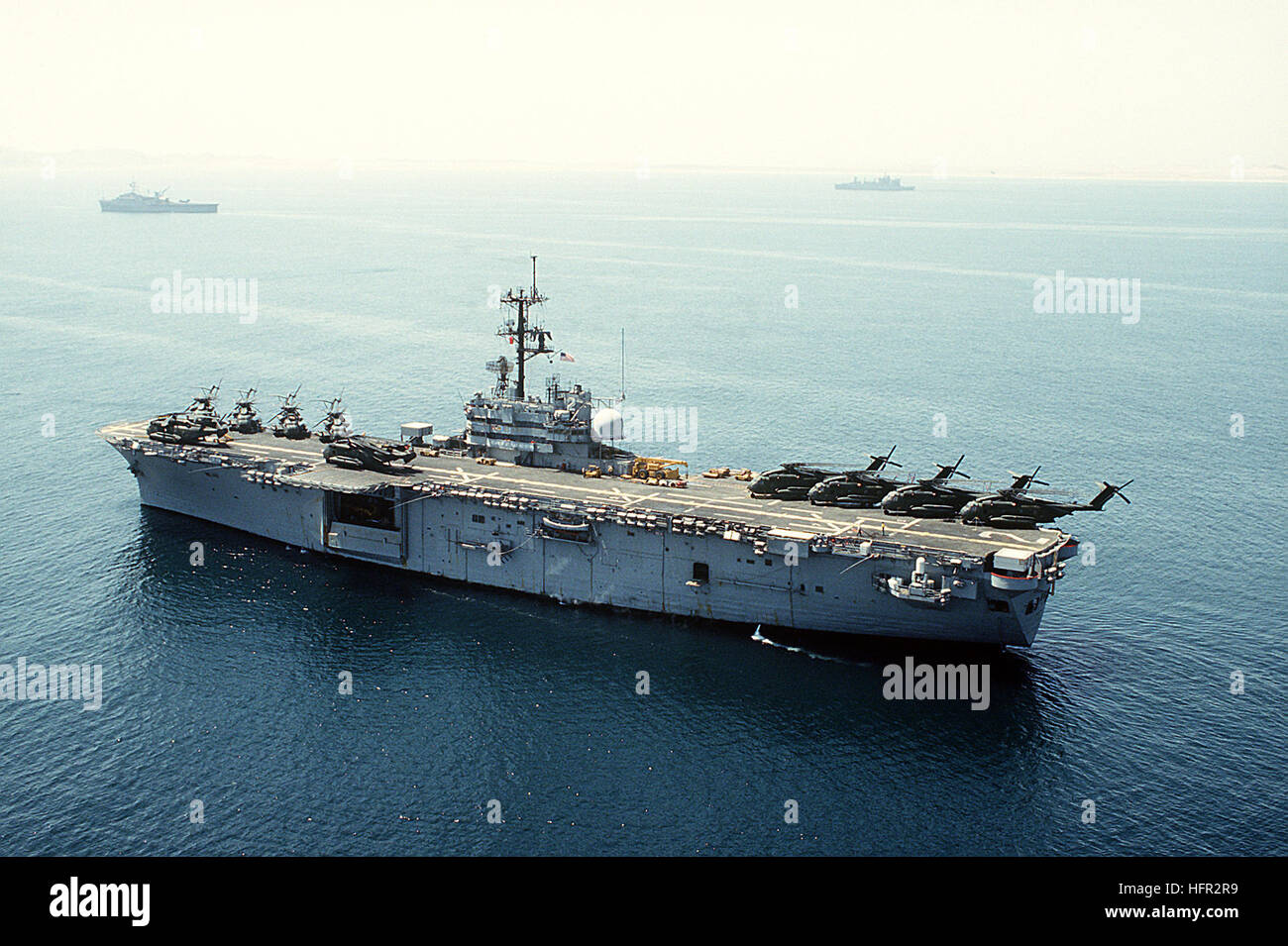 Various helicopters line the deck of the amphibious assault ship USS ...
