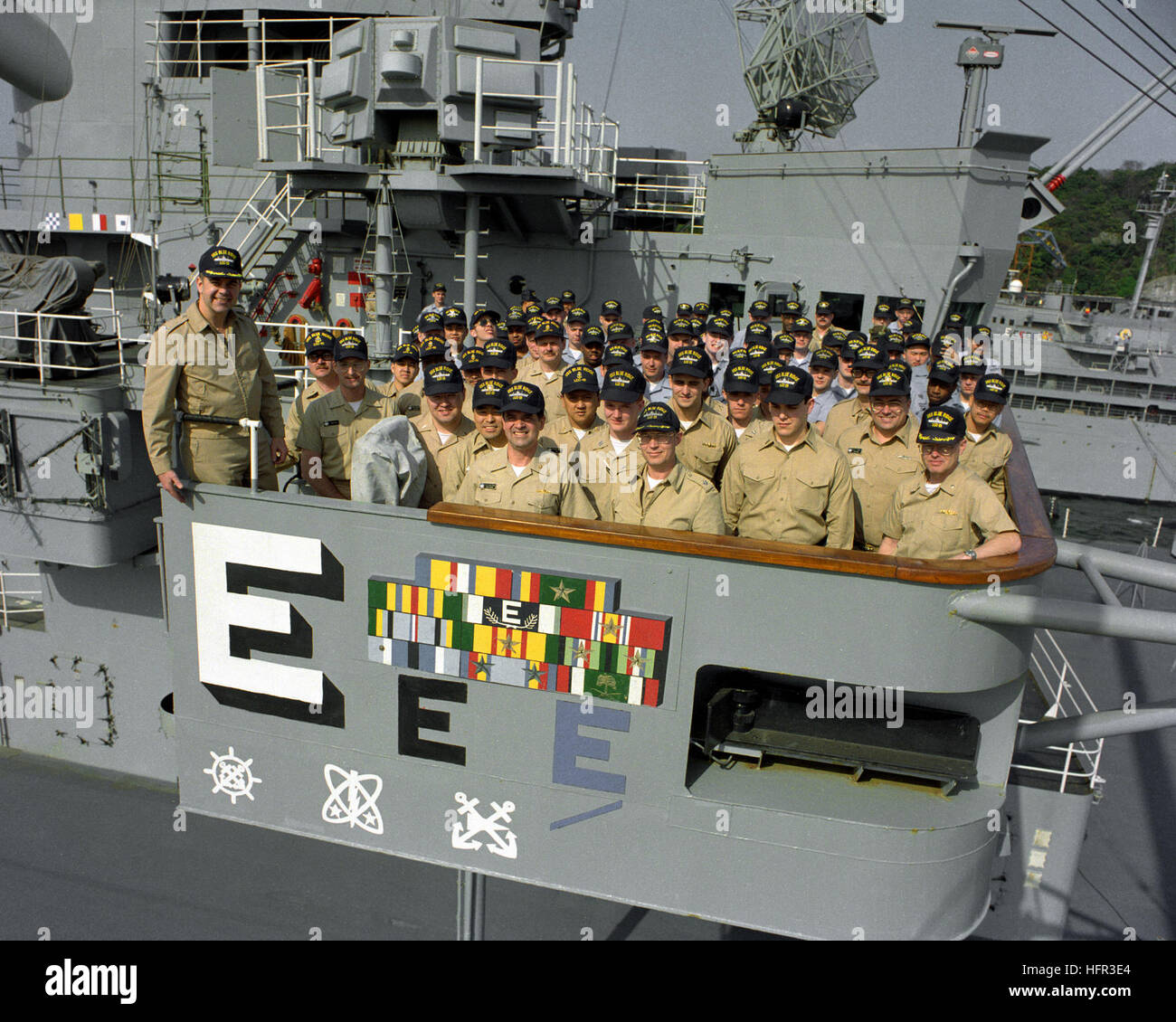 Officers and crew members of the amphibious command ship USS BLUE RIDGE (LCC-19) pose for a ...