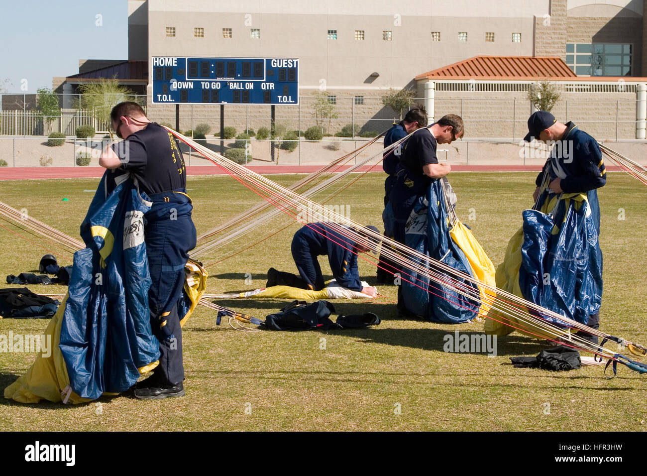 U.S. Navy Parachute Team Leap Frogs crew members repack gear after a ...