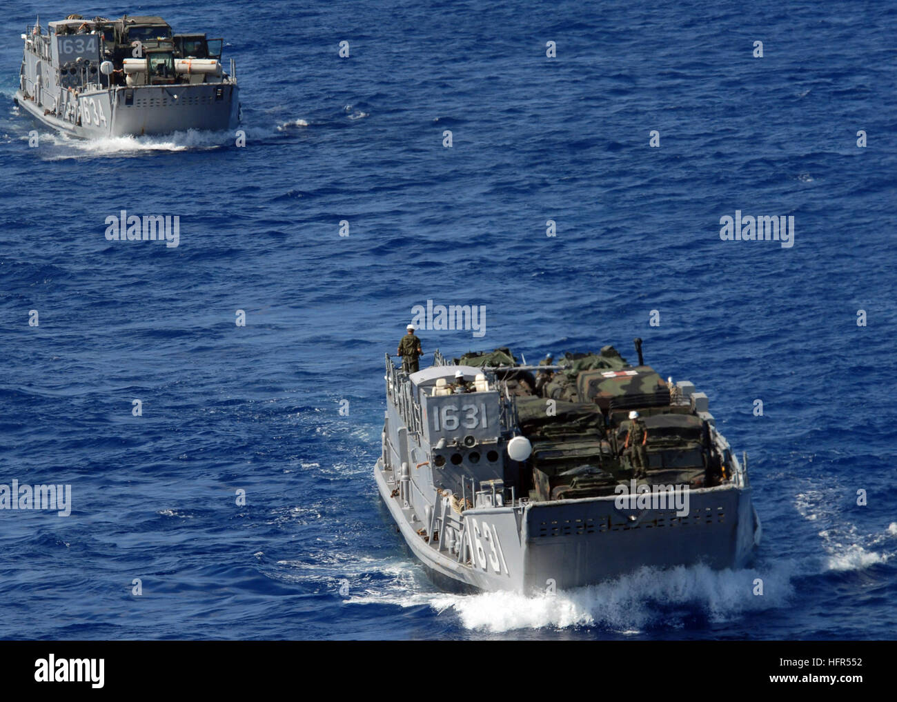 A landing craft utility enters the well deck of USS Tortuga while ...