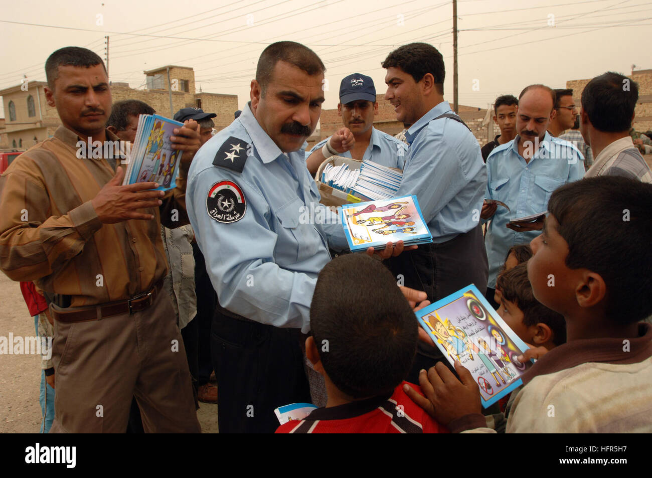 1st LT. Jumae and other Police Officers hands out school supplies to ...