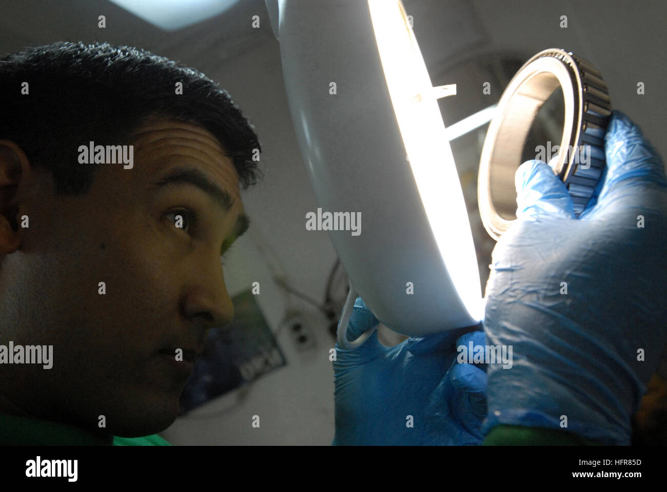 An Aviation Structural Mechanic inspects an aircraft tire bearing ...
