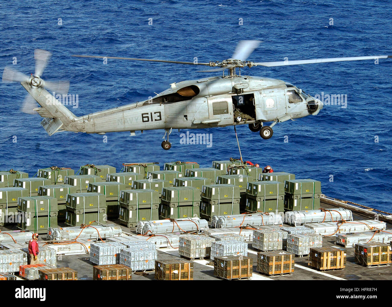 SH-60 Seahawk from HS-2 conducts weapons offload from USS Abraham ...