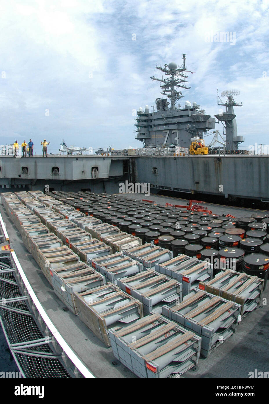 Ammunition is offloaded from the hangar to the flight deck aboard USS ...