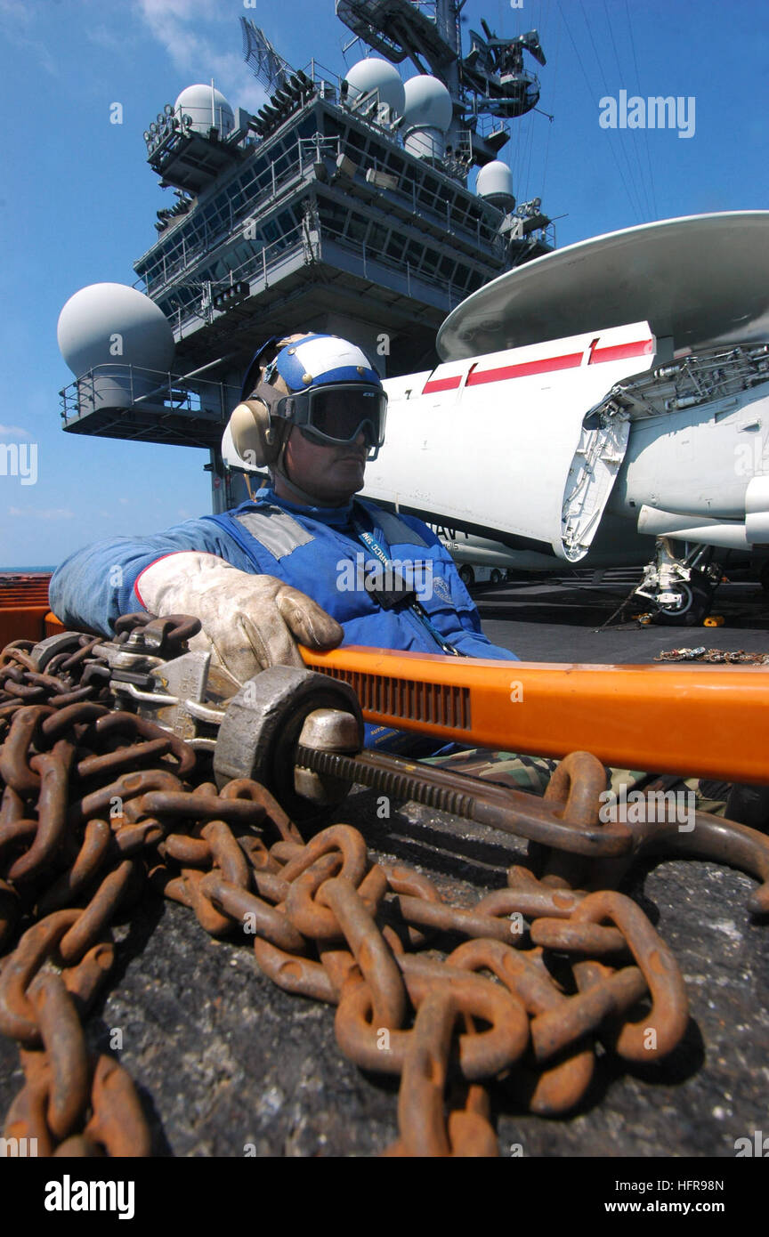 USS Kitty Hawk (CV 63) prepares an F/A-18C Hornet for launch using ...