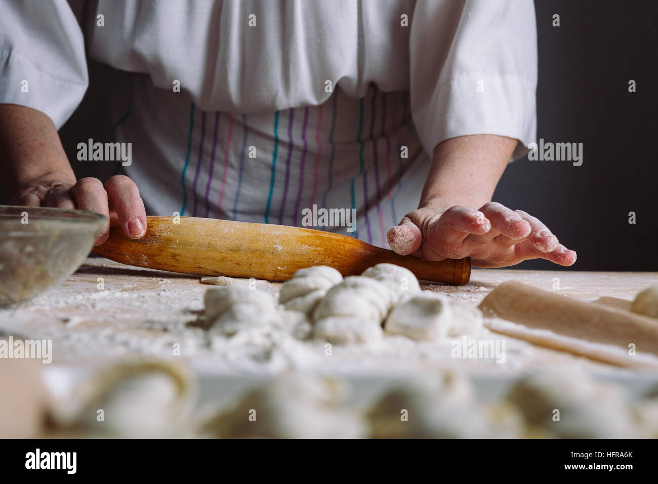 Making meat dumpling with wooden rolling pin Stock Photo - Alamy