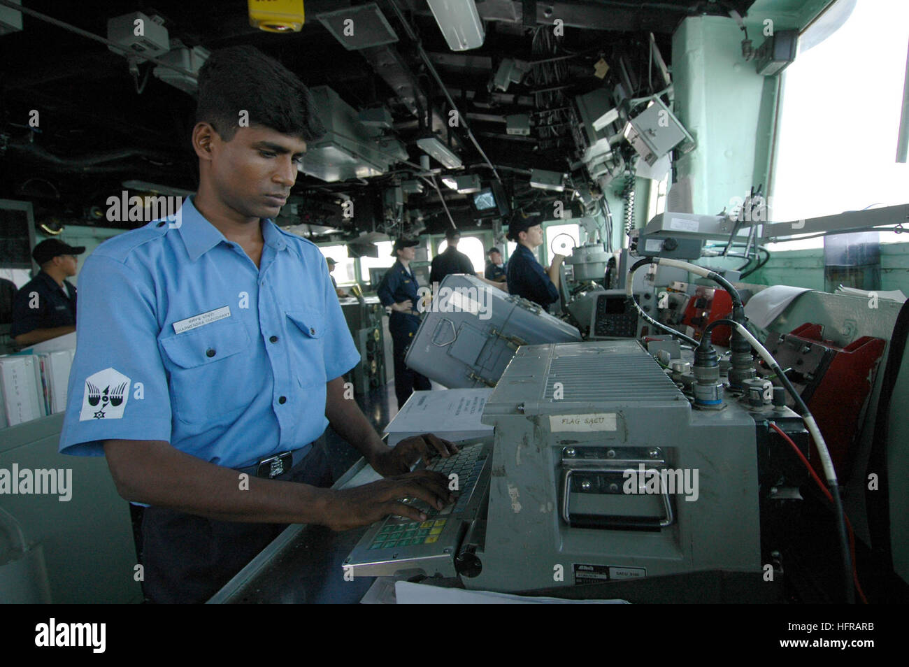 USS Bunker Hill (CG 52) bridge hosts an Indian navy radioman reviewing ...