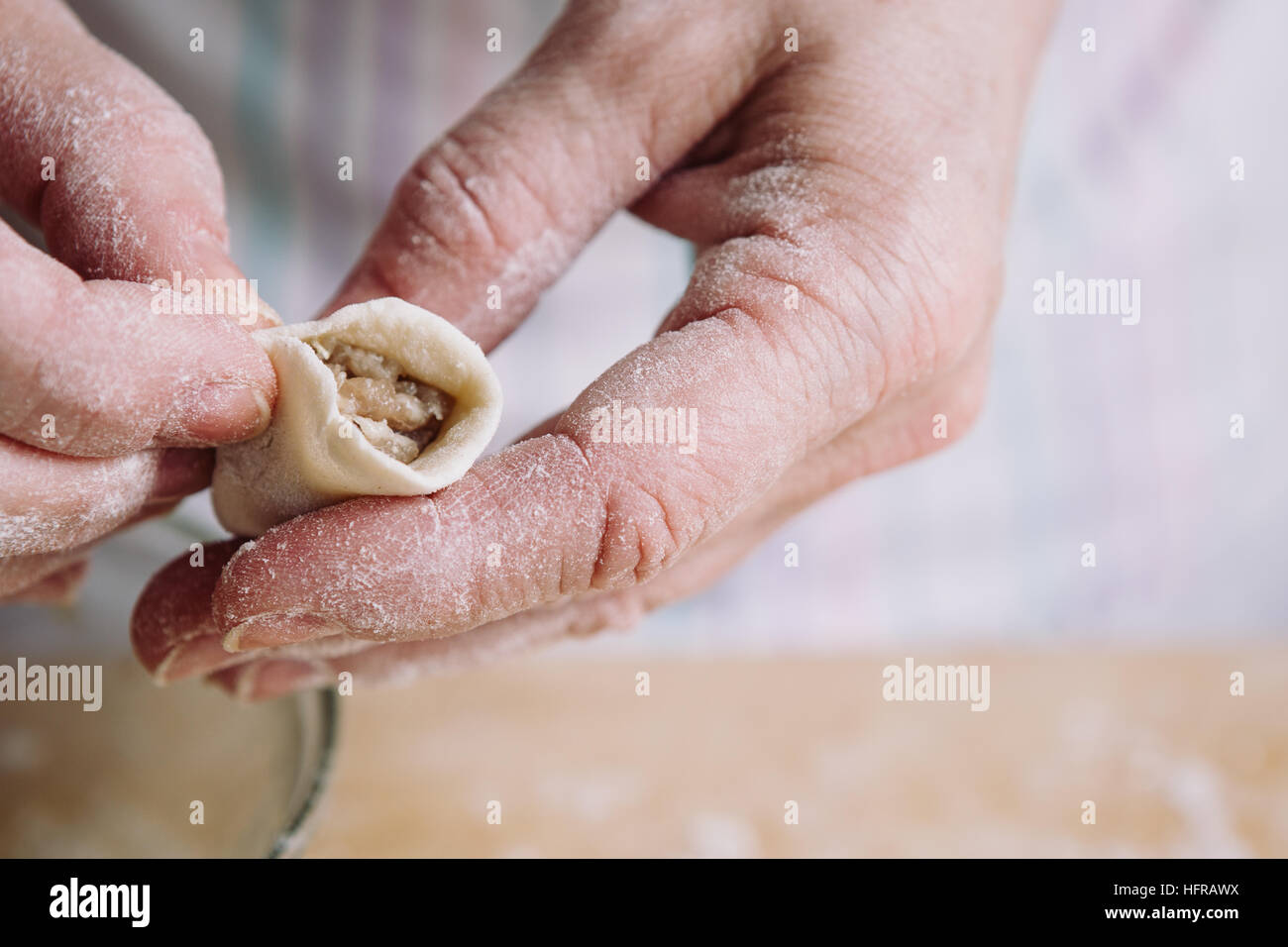 Two hands making meat dumplings Stock Photo - Alamy