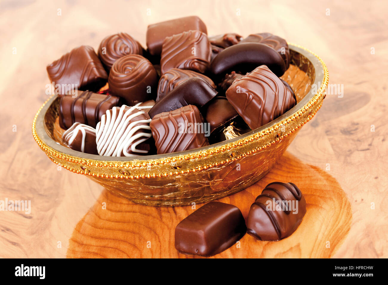 Pralines in a gold-coloured bowl Stock Photo - Alamy