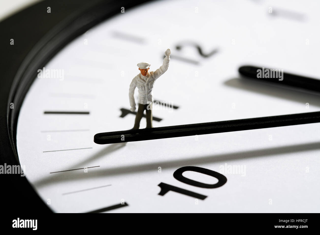 Police officer standing on a clock: stopping time Stock Photo - Alamy