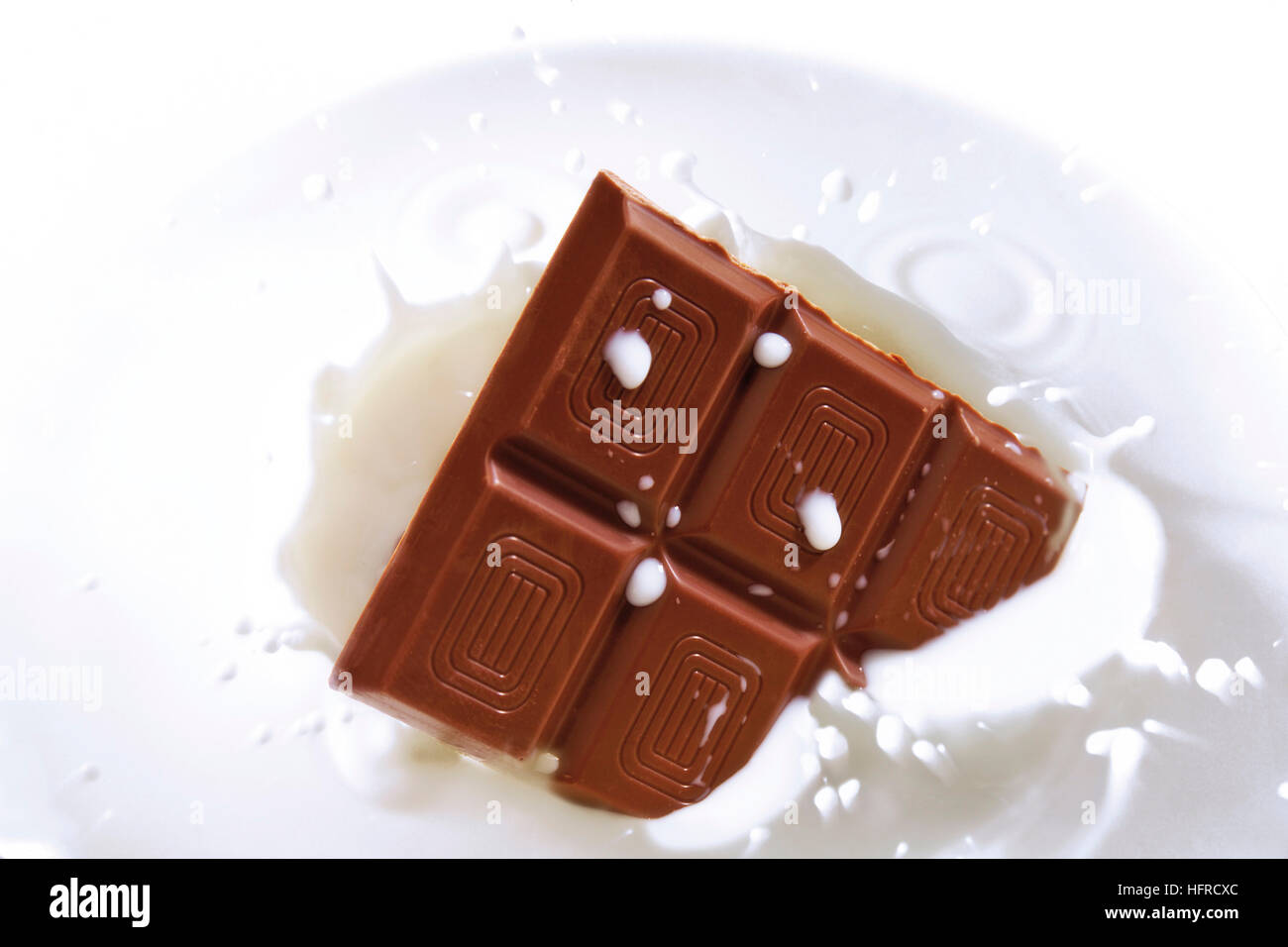 Chocolate falling into milk Stock Photo - Alamy