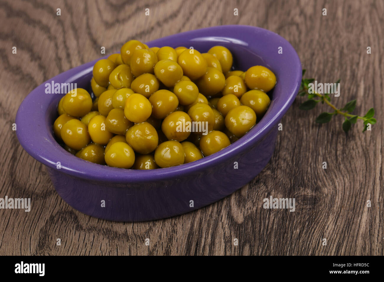 Pickled pea in the plate over wooden background Stock Photo - Alamy
