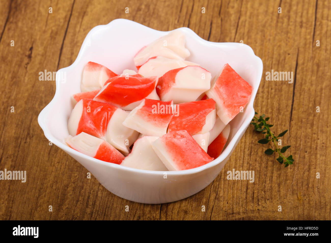 Crab stick - surimi in the plate - over wood background Stock Photo - Alamy