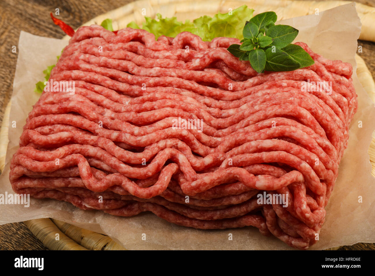 Minced beef meat with basil leaves ready for cooking Stock Photo - Alamy
