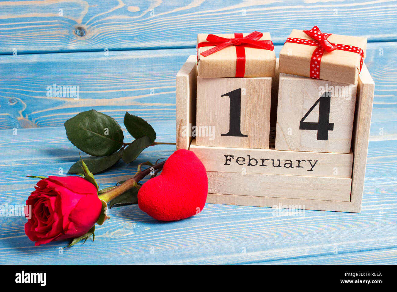 February 14 on cube calendar, wrapped gift with ribbon, red heart and ...