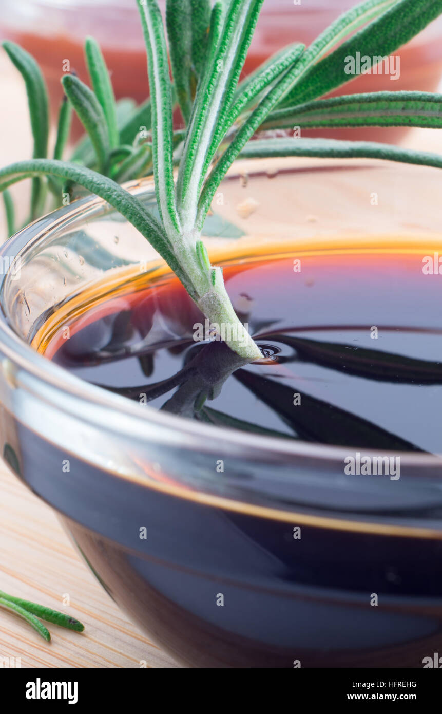 Kitchen condiment closeup - glass cup with soy sauce, which are ...