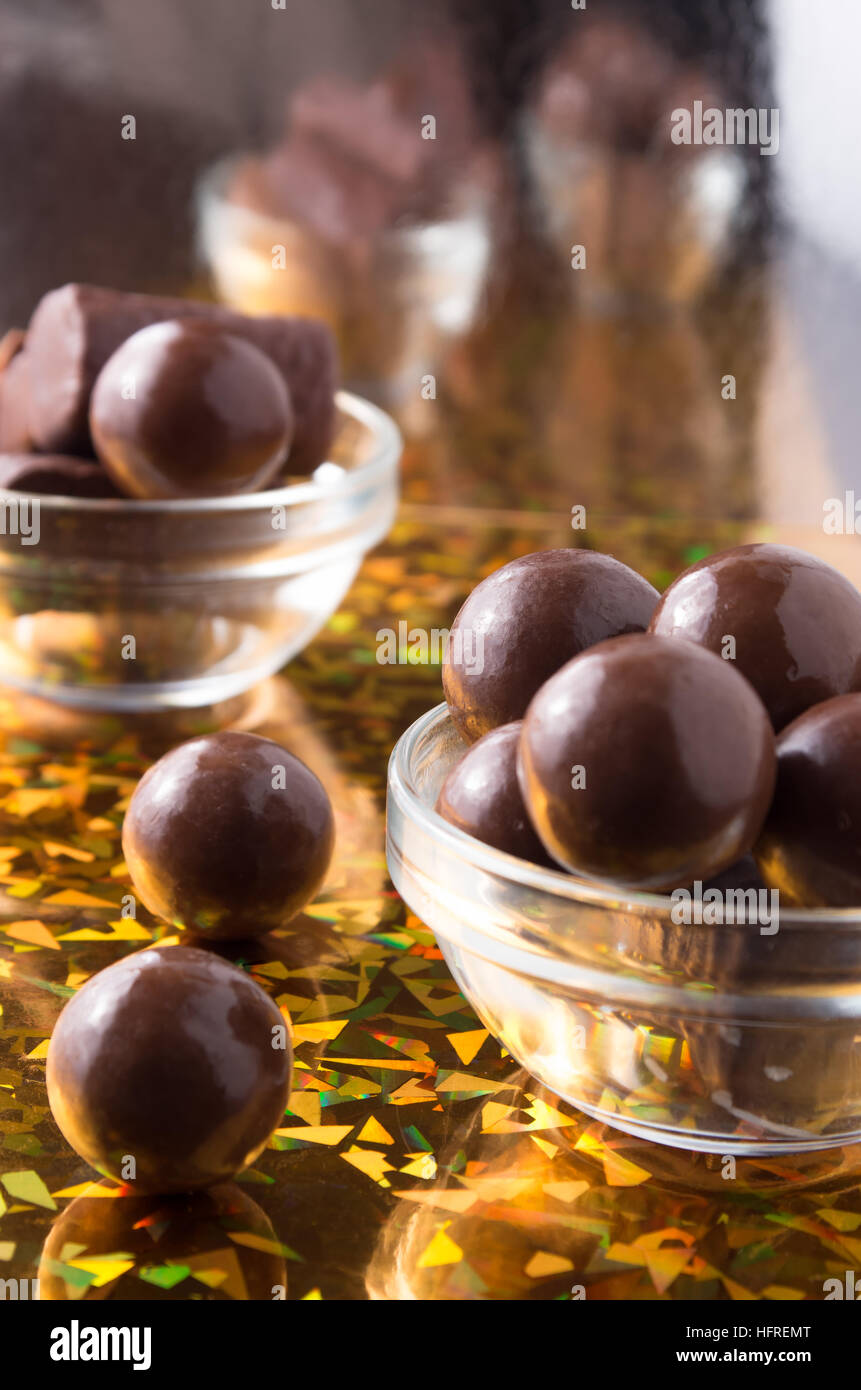 Chocolate candy round close-up on a colorful background with blur and a ...
