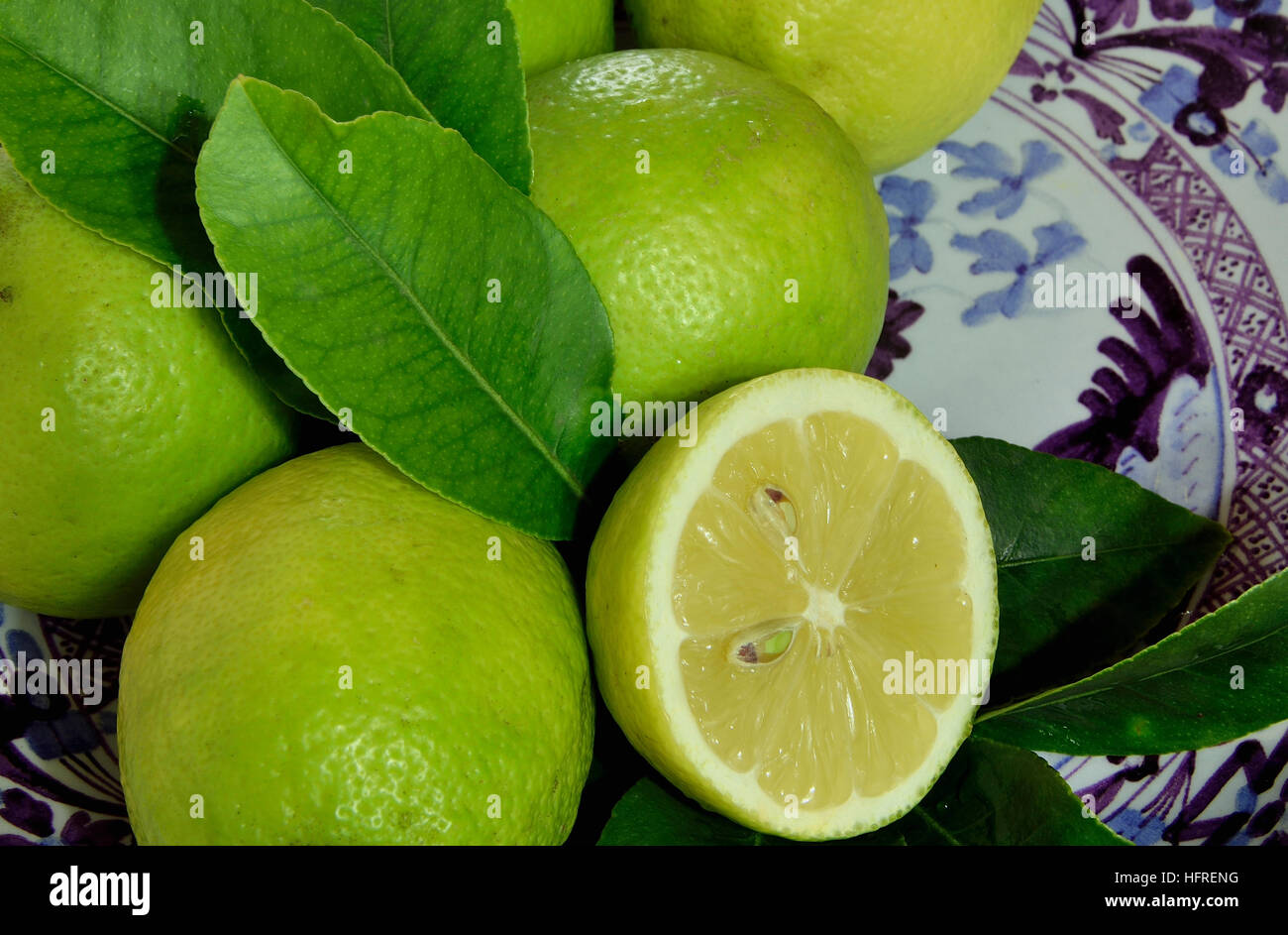 Freshly lemons in a blue plate Stock Photo - Alamy