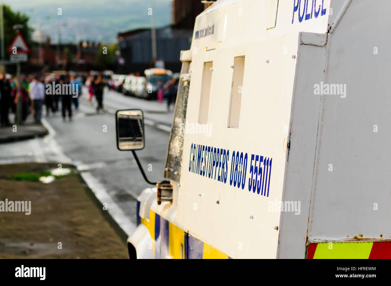 PSNI landrover waits while monitoring a gathering crowd of youths in ...